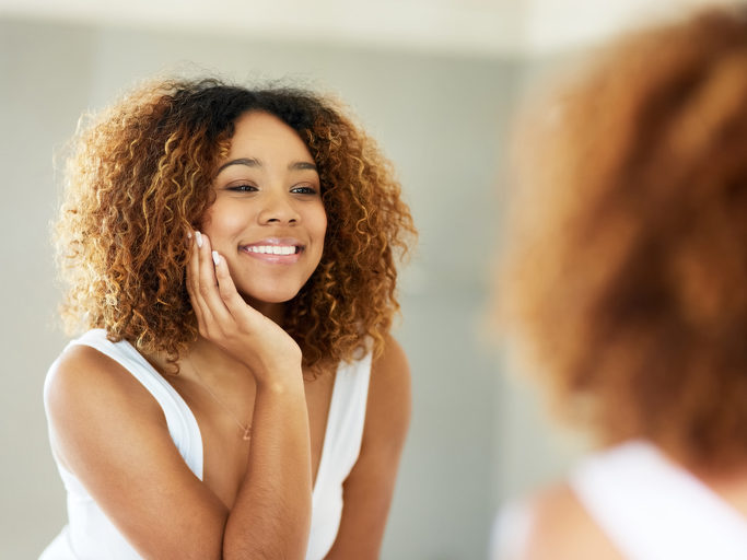 Person Looking In The Mirror Smiling